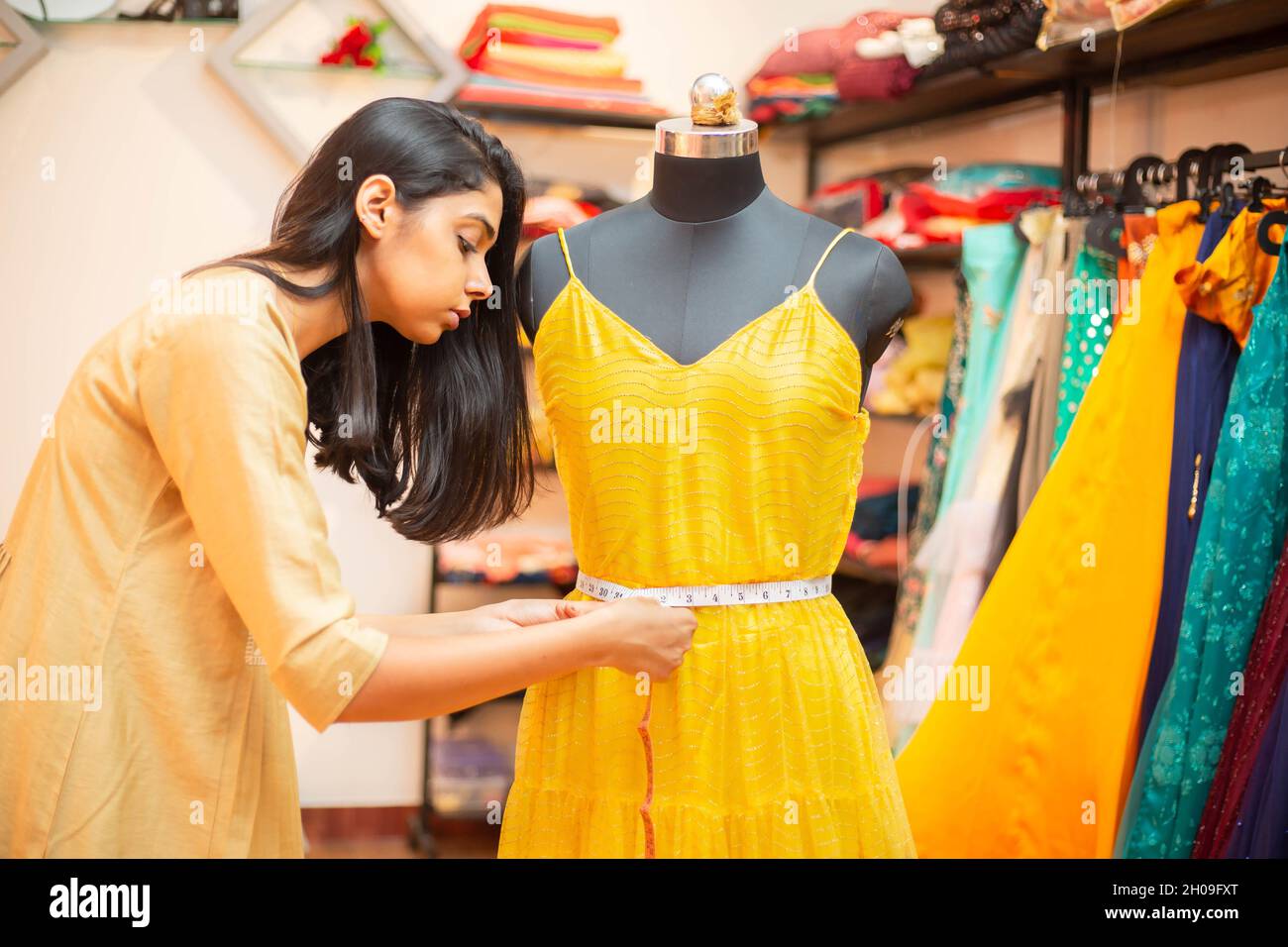 Young indian happy woman,tailor,fashion designer,dressmaker checking ...