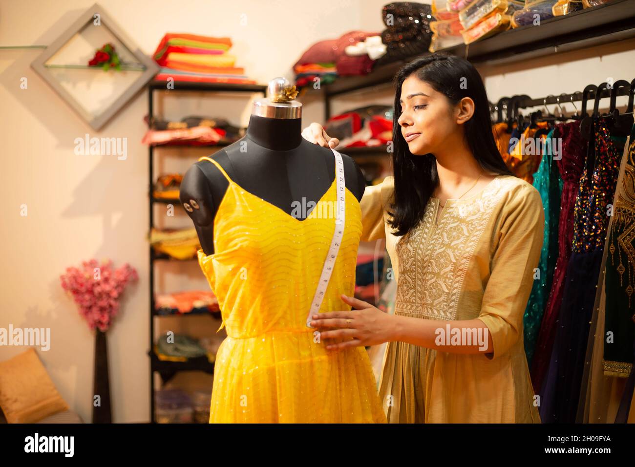 Young indian happy woman,tailor,fashion designer,dressmaker checking ...