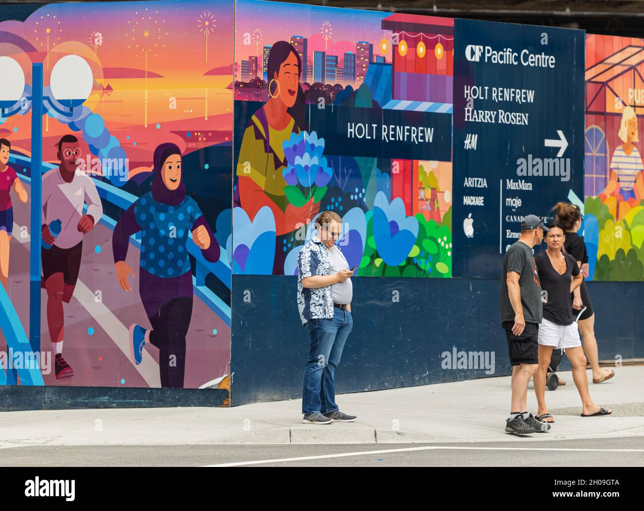 People walking on a street of a city in the big poster on the ...