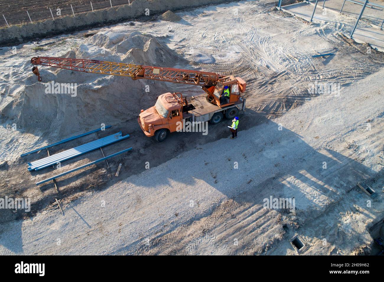 Aerial images of engineer and worker talking at building site Stock ...