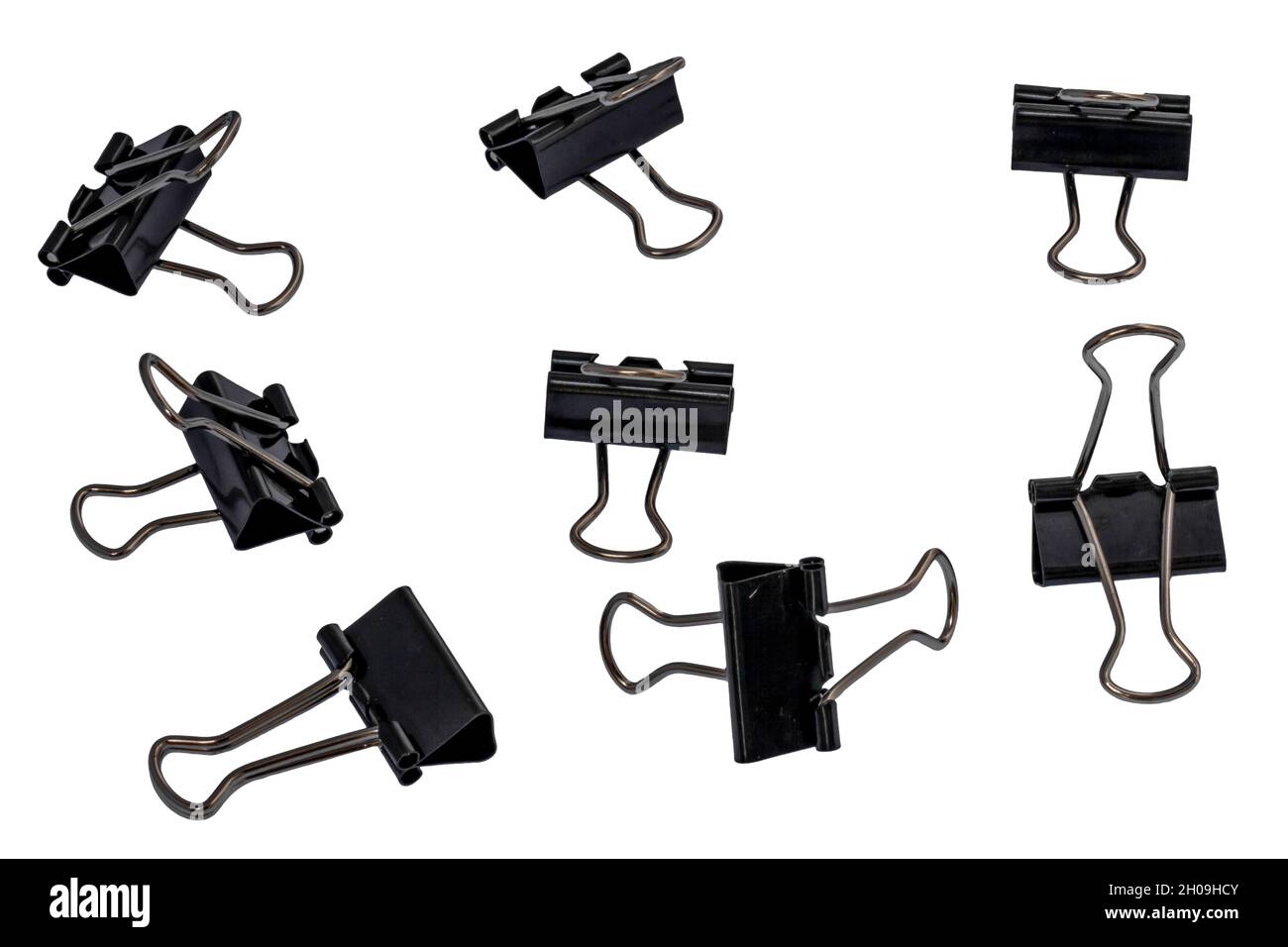A group of metal paper clips in black, isolated on a white background ...