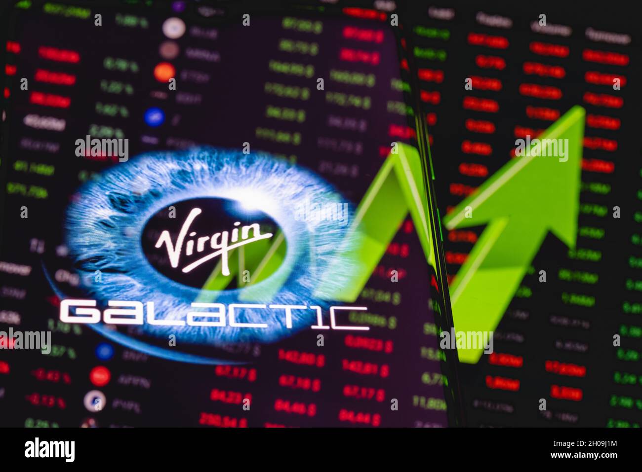 Virgin Galactic logo on the background of a large green arrow pointing ...