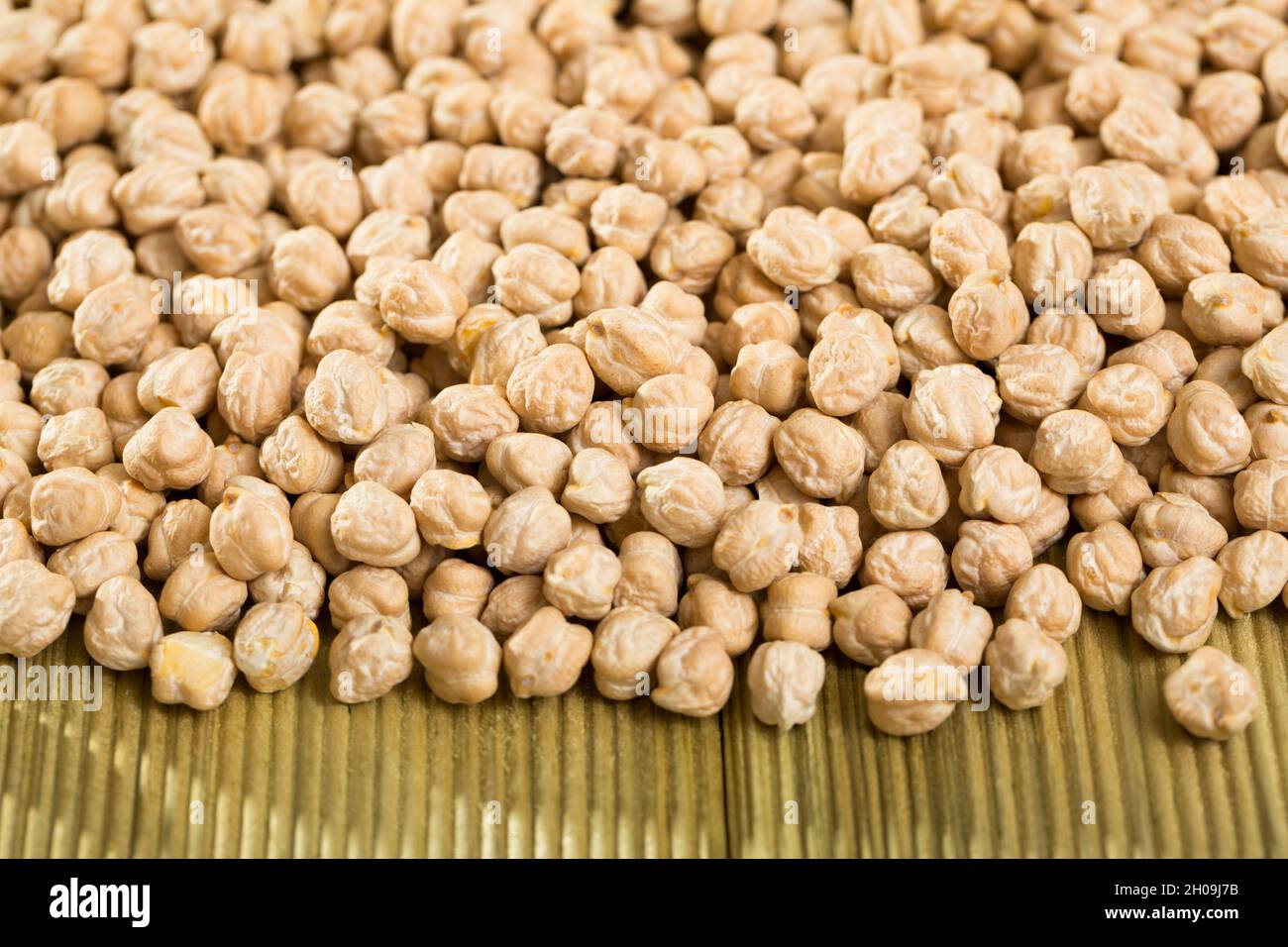 Closeup of background with raw garbanzo grains on wooden surface Stock ...