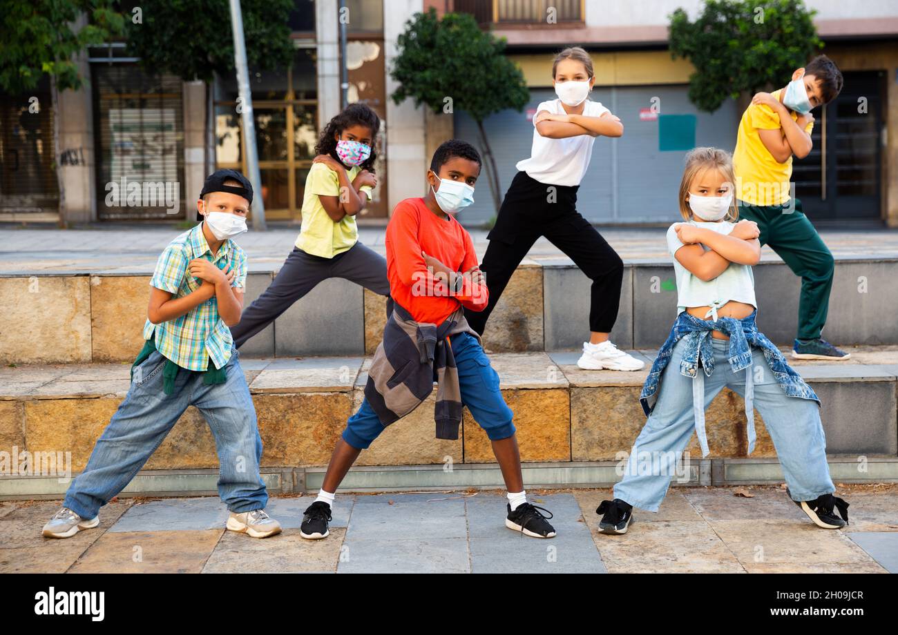 Kids in masks dancing on street Stock Photo - Alamy