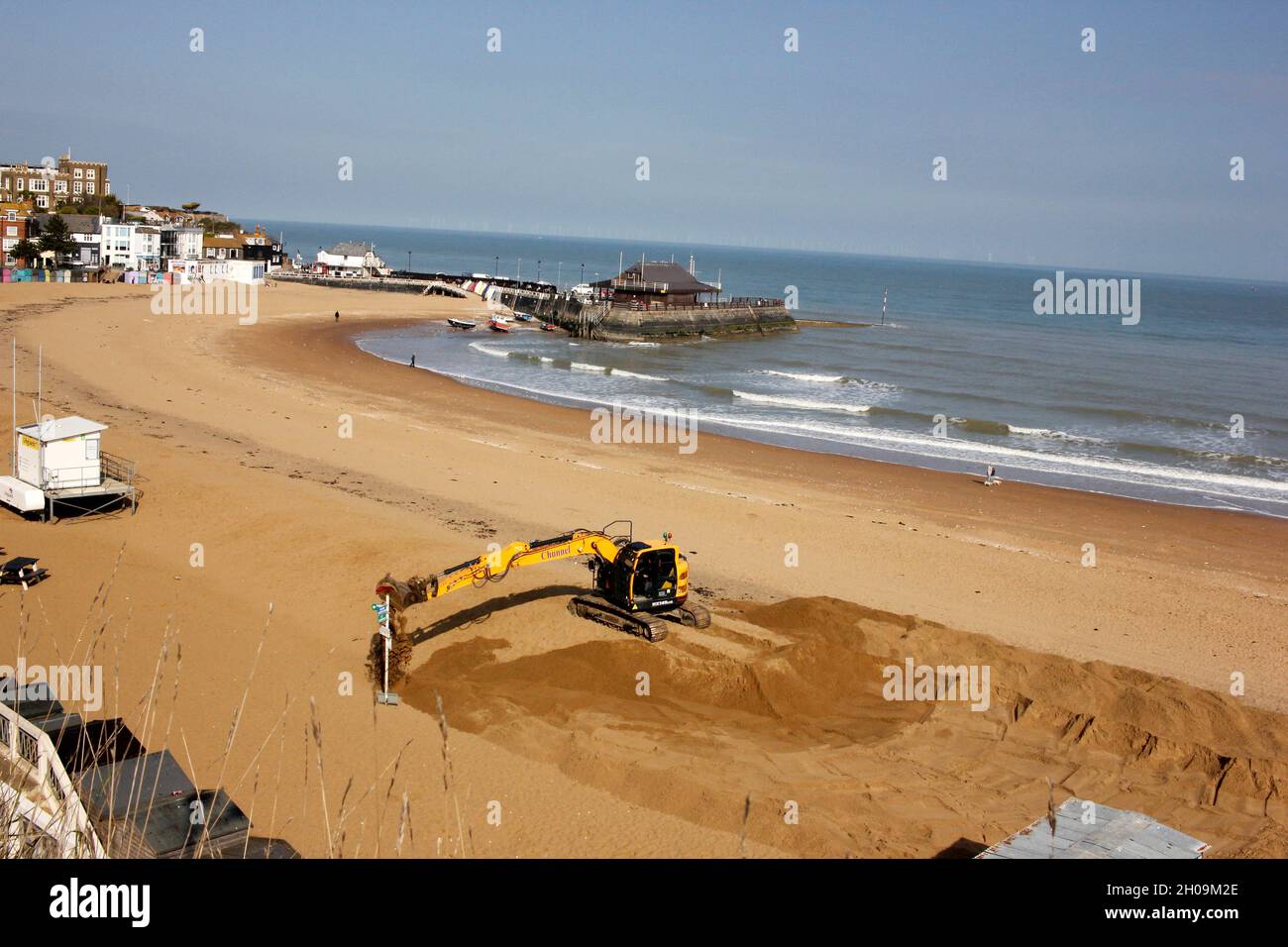 mechanical sand digger prepairing for summer tourist holidaymakers in ...