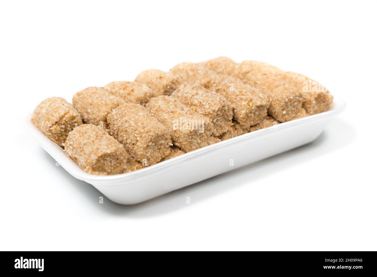 Pack of raw frozen croquettes on a white tray. Product on white ...