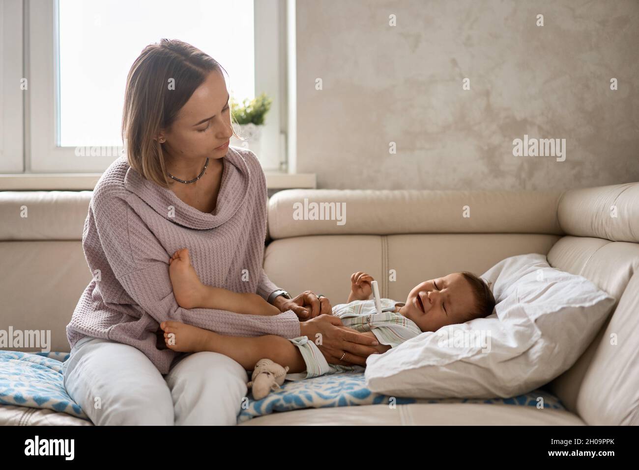 The little boy cry because of the high temperature. First year of life ...
