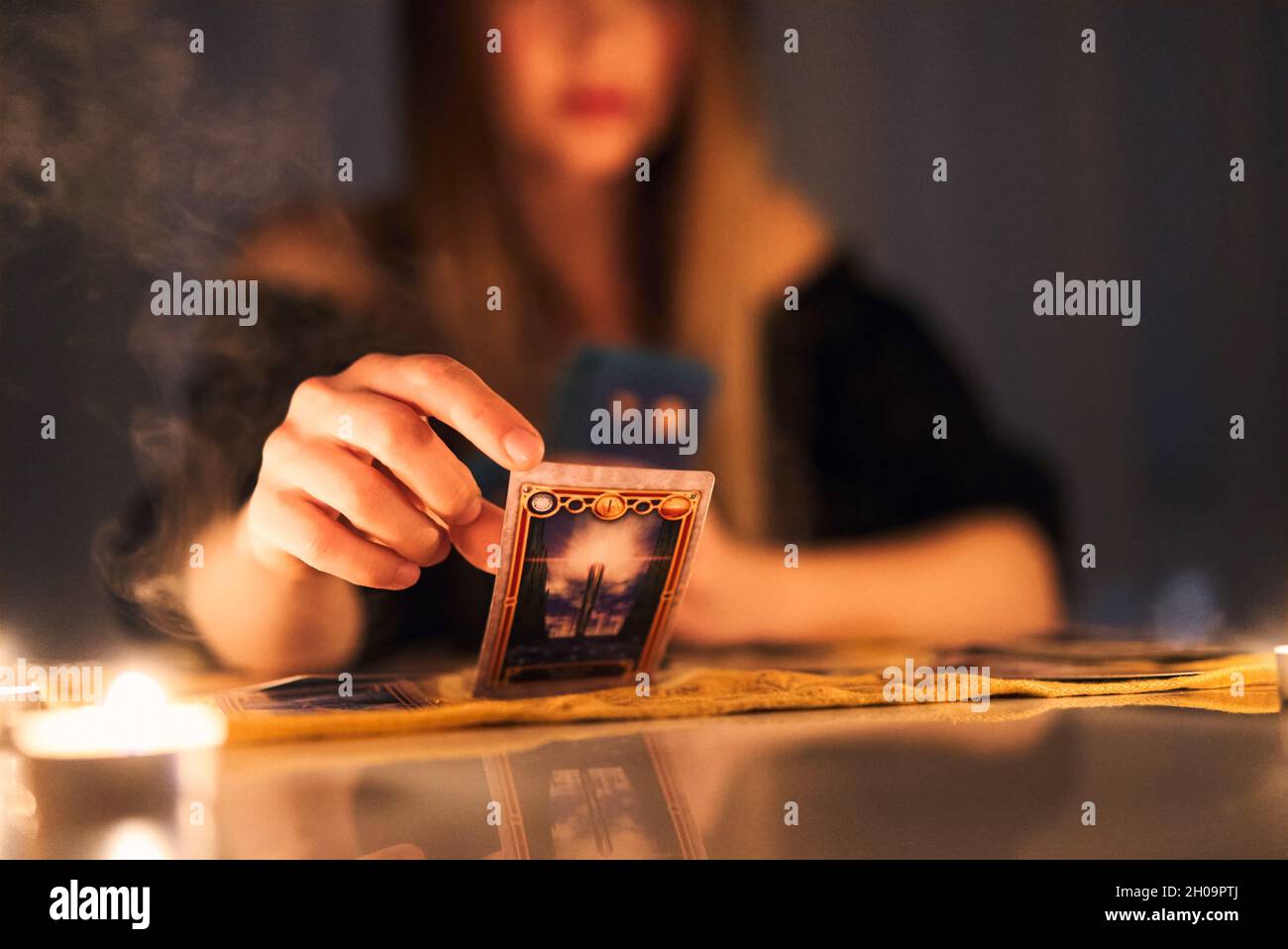Woman reading tarot cards in spiritual room Stock Photo - Alamy