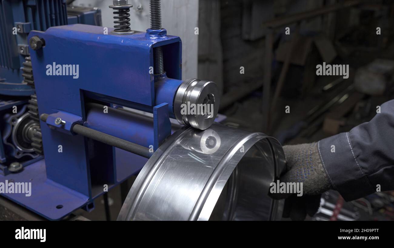 Image of man working on sheet bending machine Stock Photo - Alamy