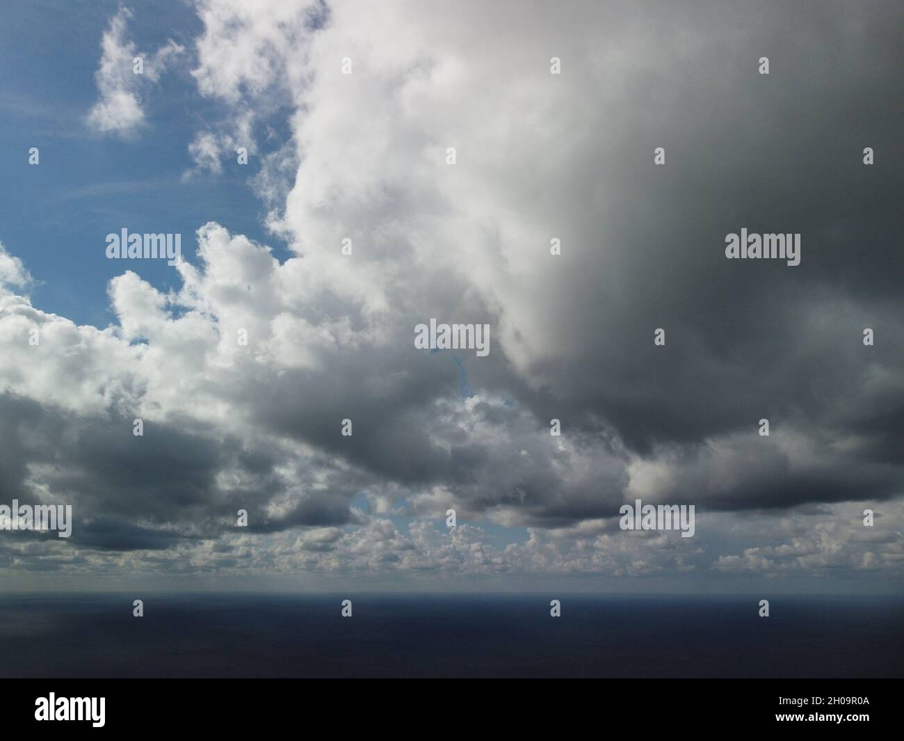 Abstract airy sky with moving plump clouds over the sea ocean. Small ...