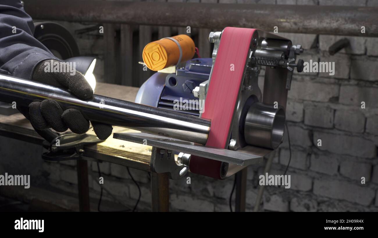 Working process on lathe with grinding belt in workshop Stock Photo - Alamy