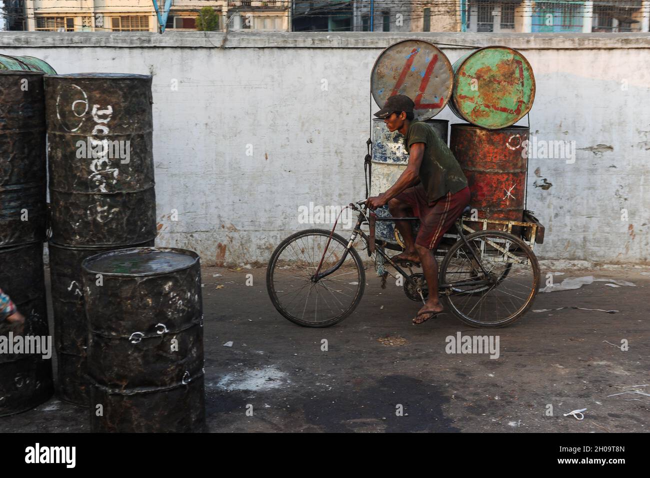 "30.01.2014, Myanmar, , Yangon - A rickshaw driver carries empty, rusty ...