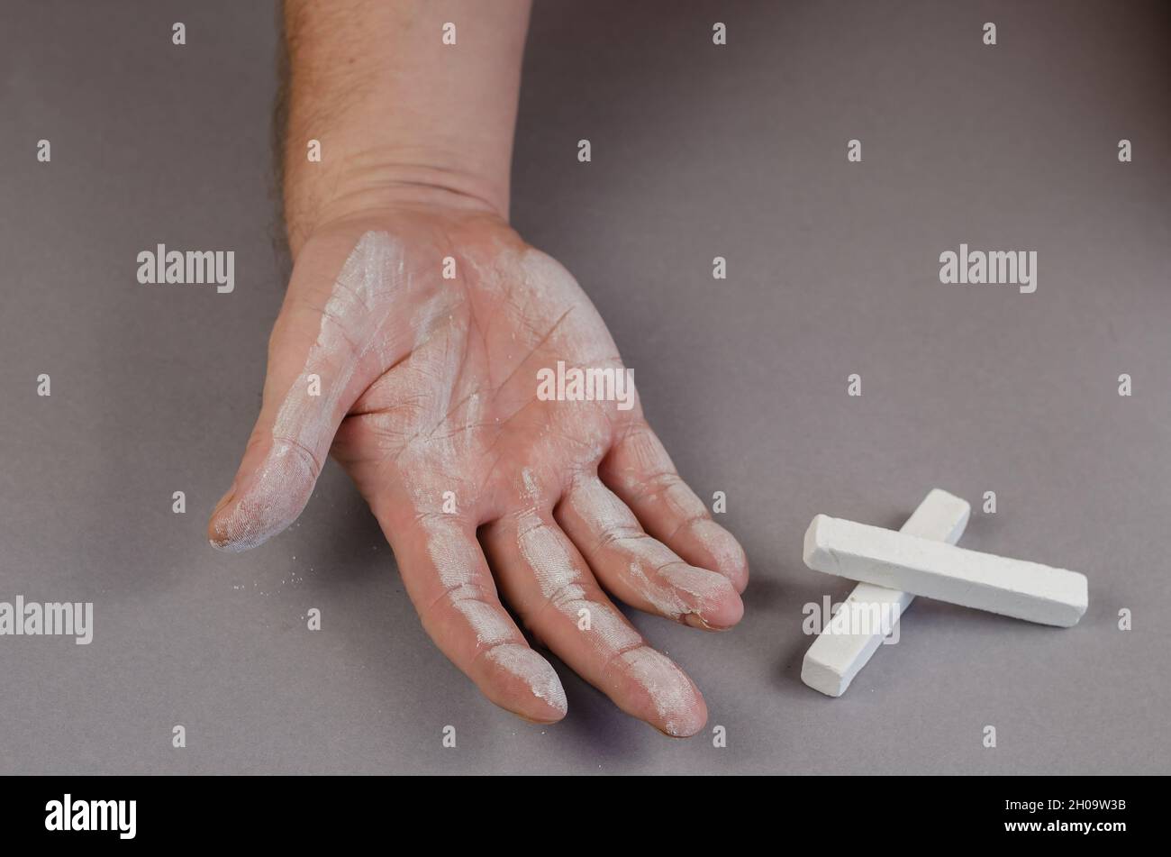 Pieces of chalk. Man's hand stained with white chalk. Right open palm ...