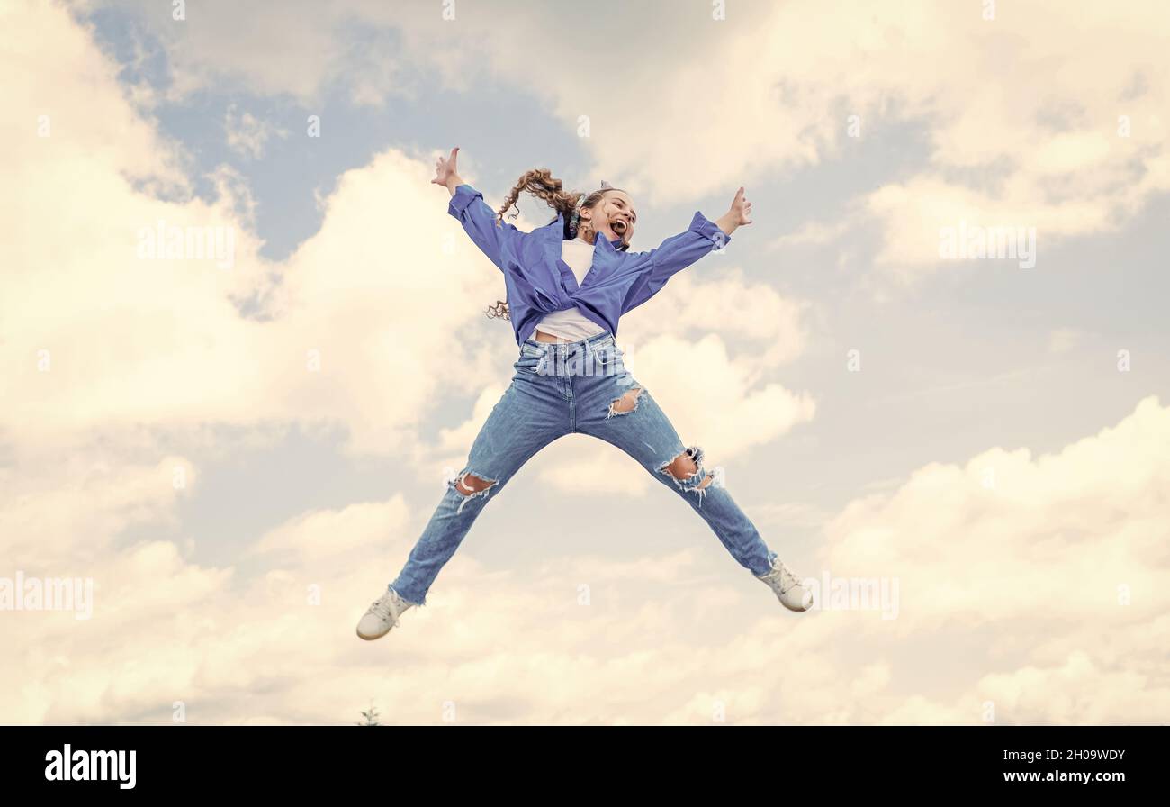 Happy curly teenager jumping hi-res stock photography and images - Alamy