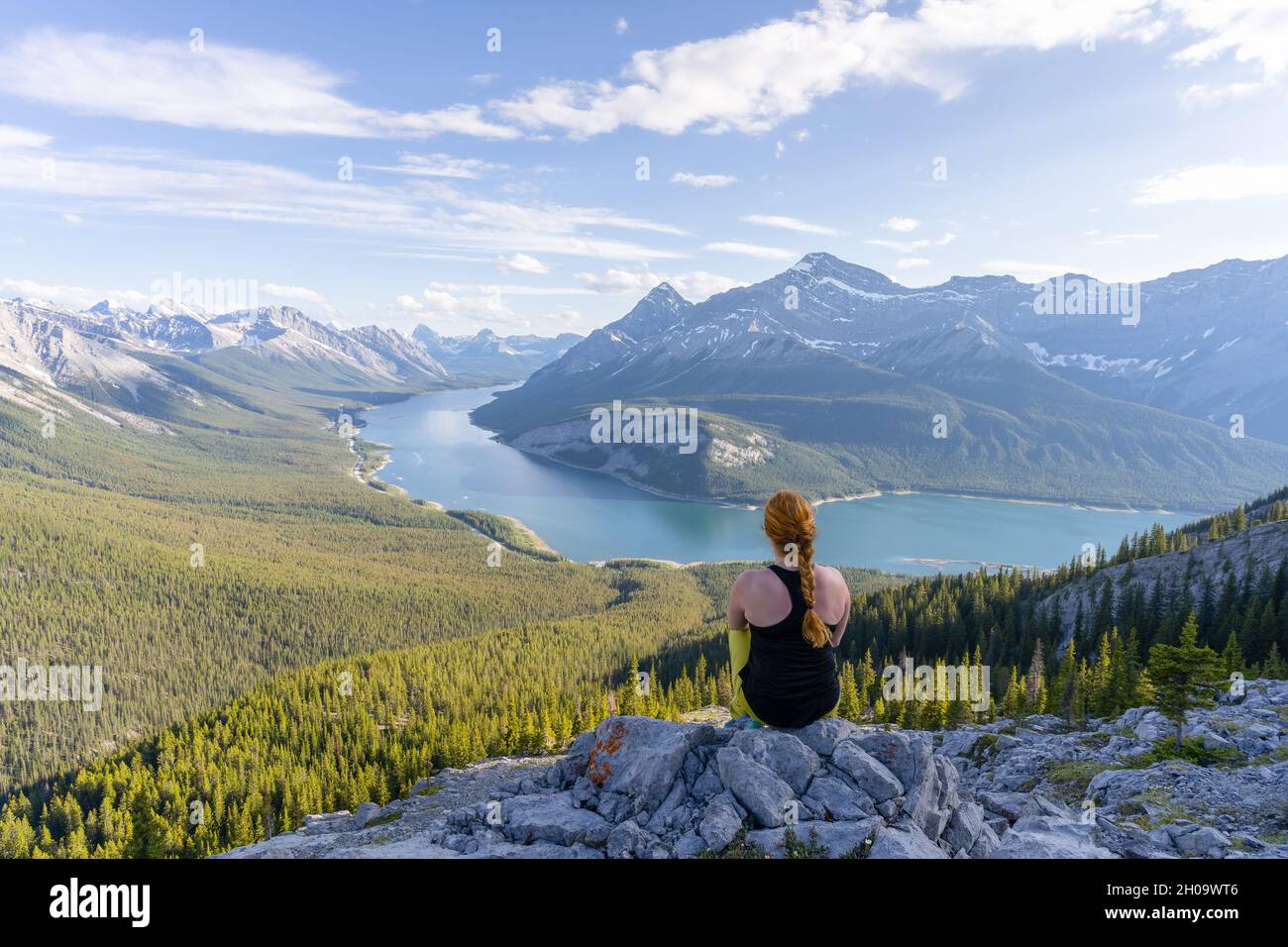 Female hiker enjoying vista on beautiful alpine valley and lake in ...