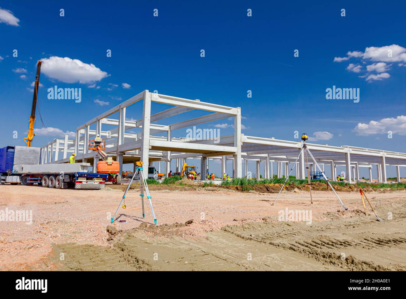 Mobile crane is assembly concrete skeleton of industrial building, with ...