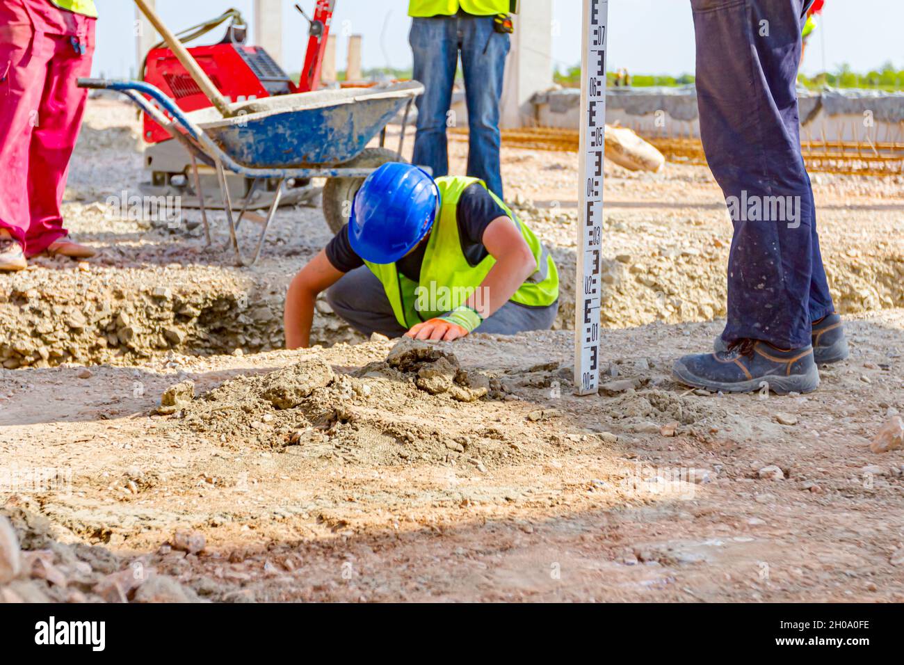 Construction worker is using tool to realign, correct measure or level ...
