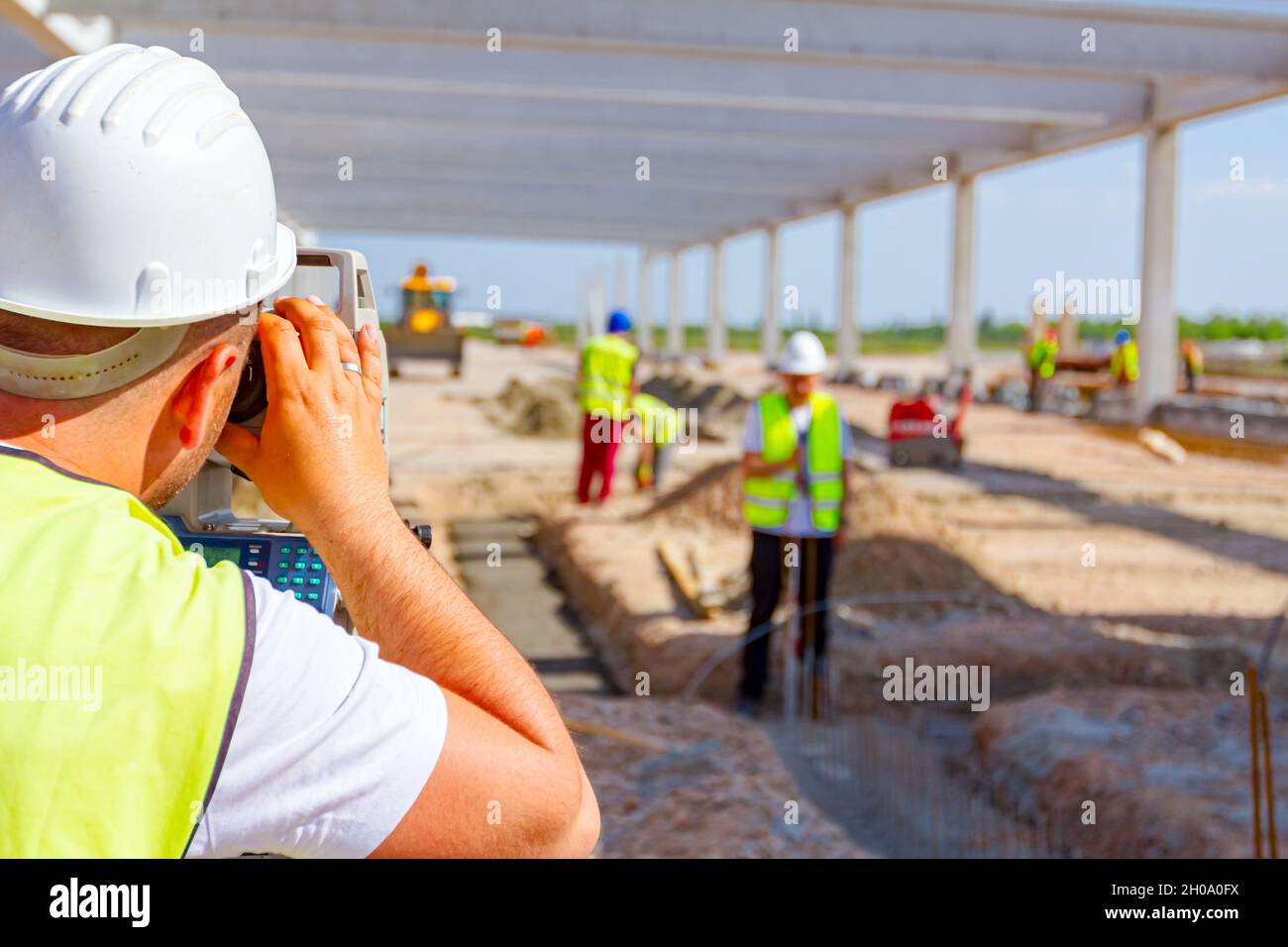 Surveyor engineer is measuring level on construction site. Surveyors ...