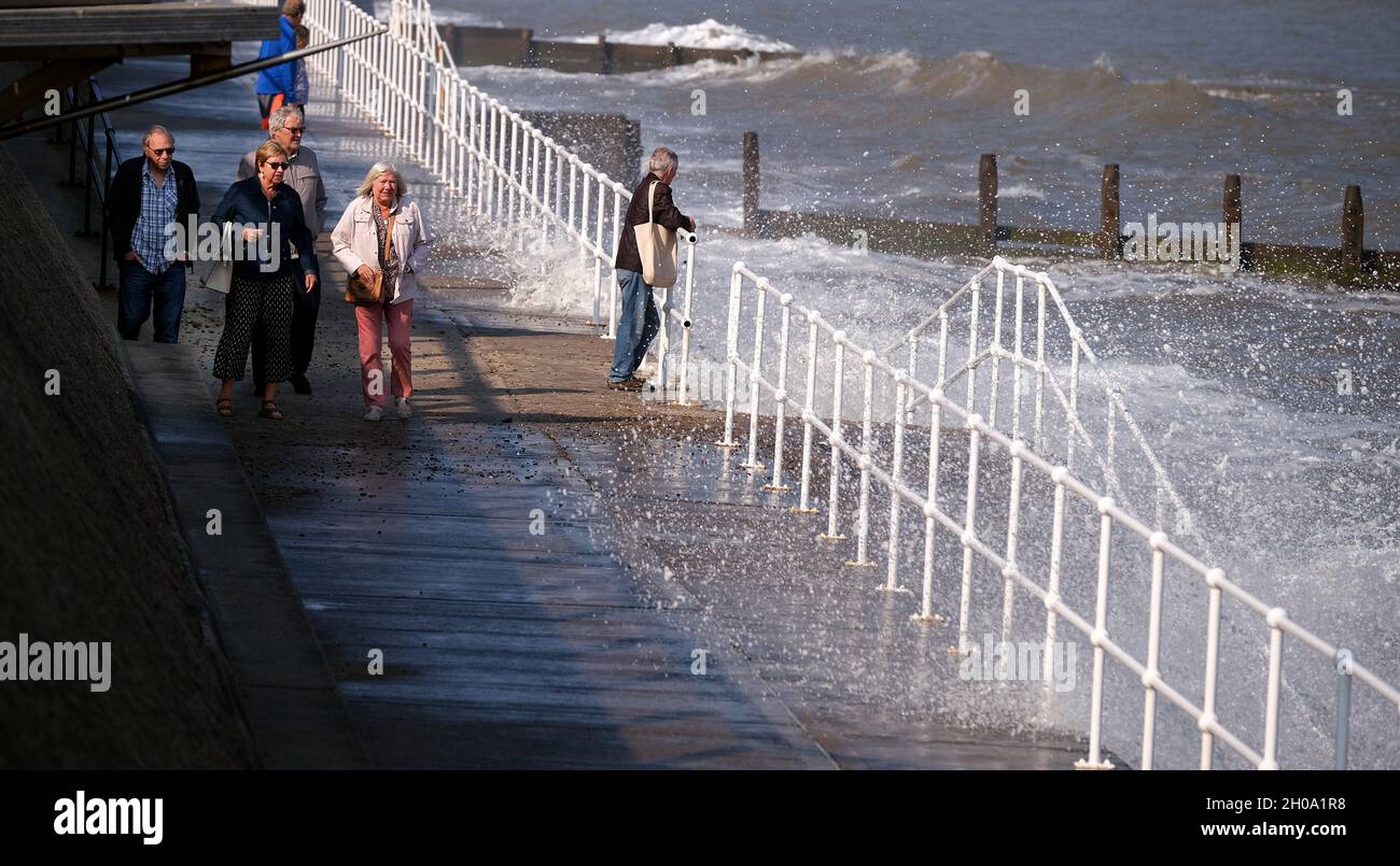 Seafront walk at high tide with waves splashing people Stock Photo - Alamy