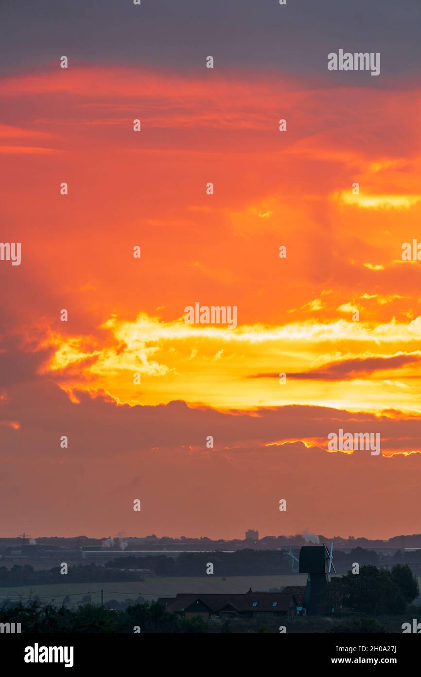 Sunrise over Kent with a former windmill silhouetted against the early ...