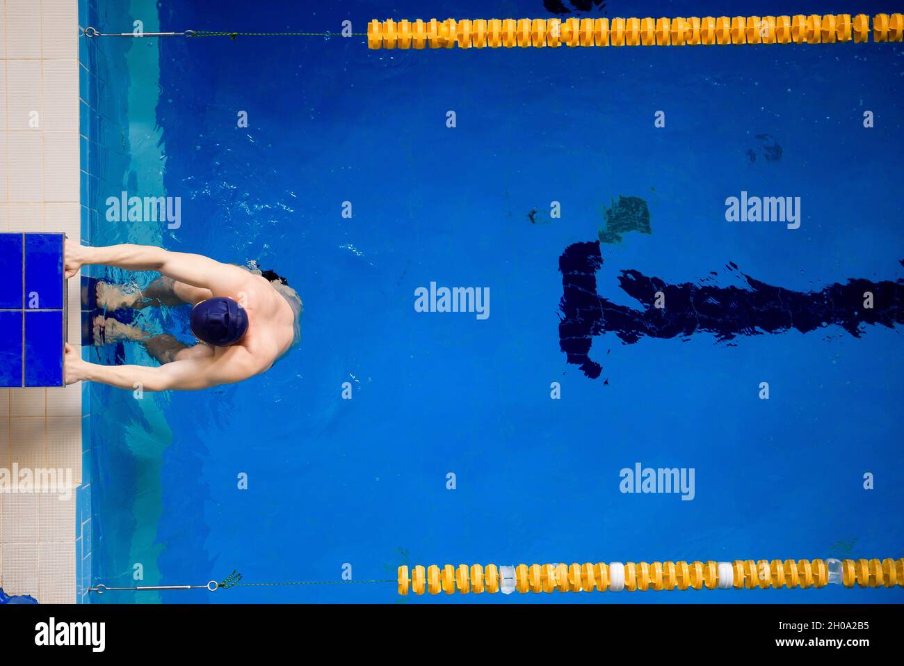 Male professional competitive swimmer in swimming pool, view from above ...