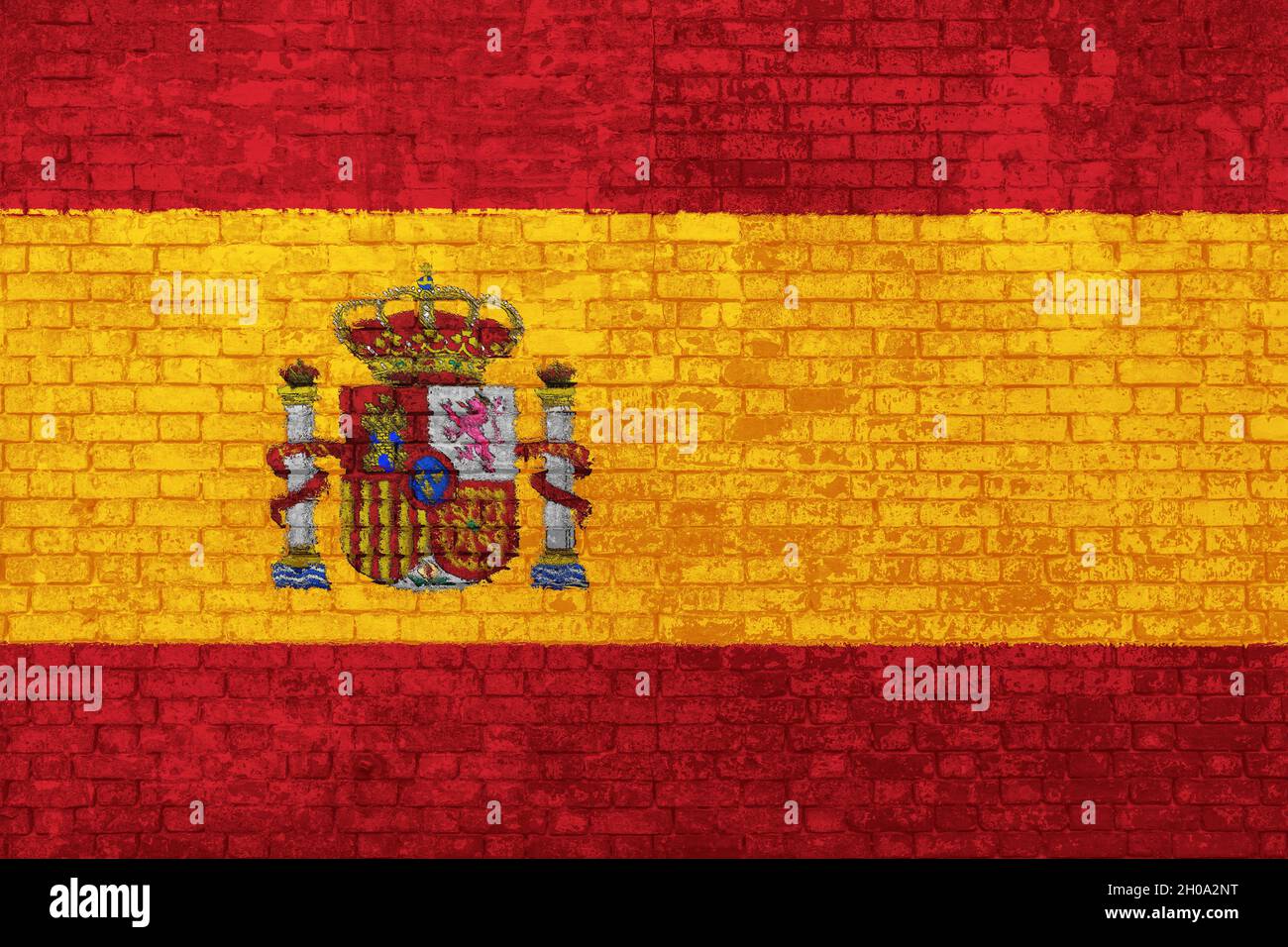 Wall of bricks painted with the flag of Spain, red and yellow colors ...