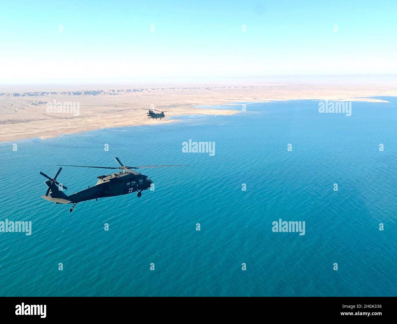 A UH-60 Black Hawk helicopter and CH-47 Chinook helicopter, operated by ...
