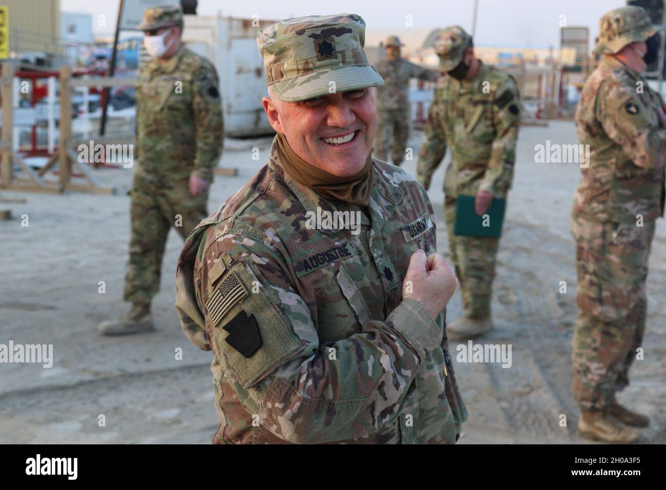 U.S. Army Lt. Col. Eric Augustine flexes for a photo after receiving ...