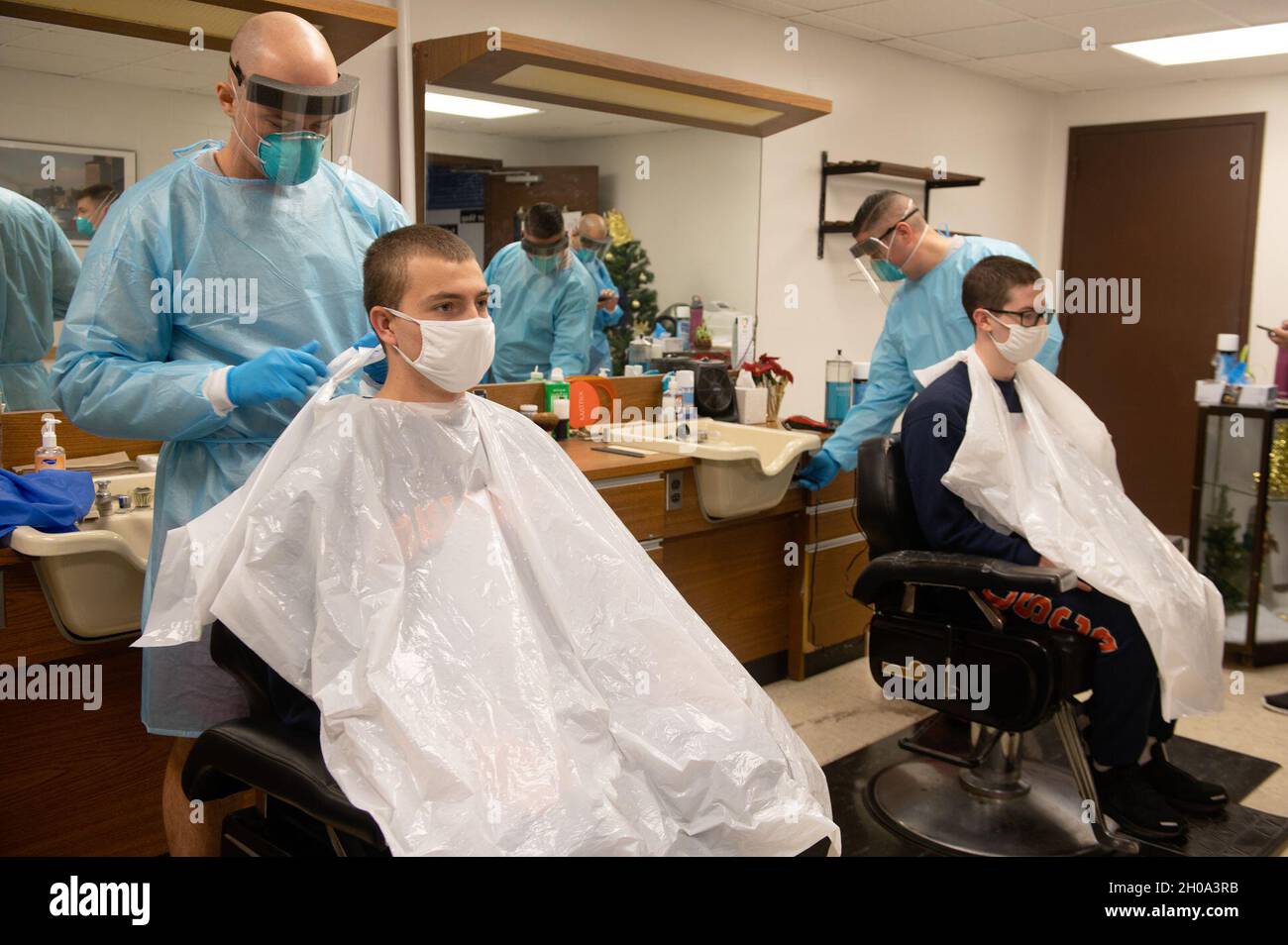 Recruits from company R-199 receive haircuts from staff members in ...