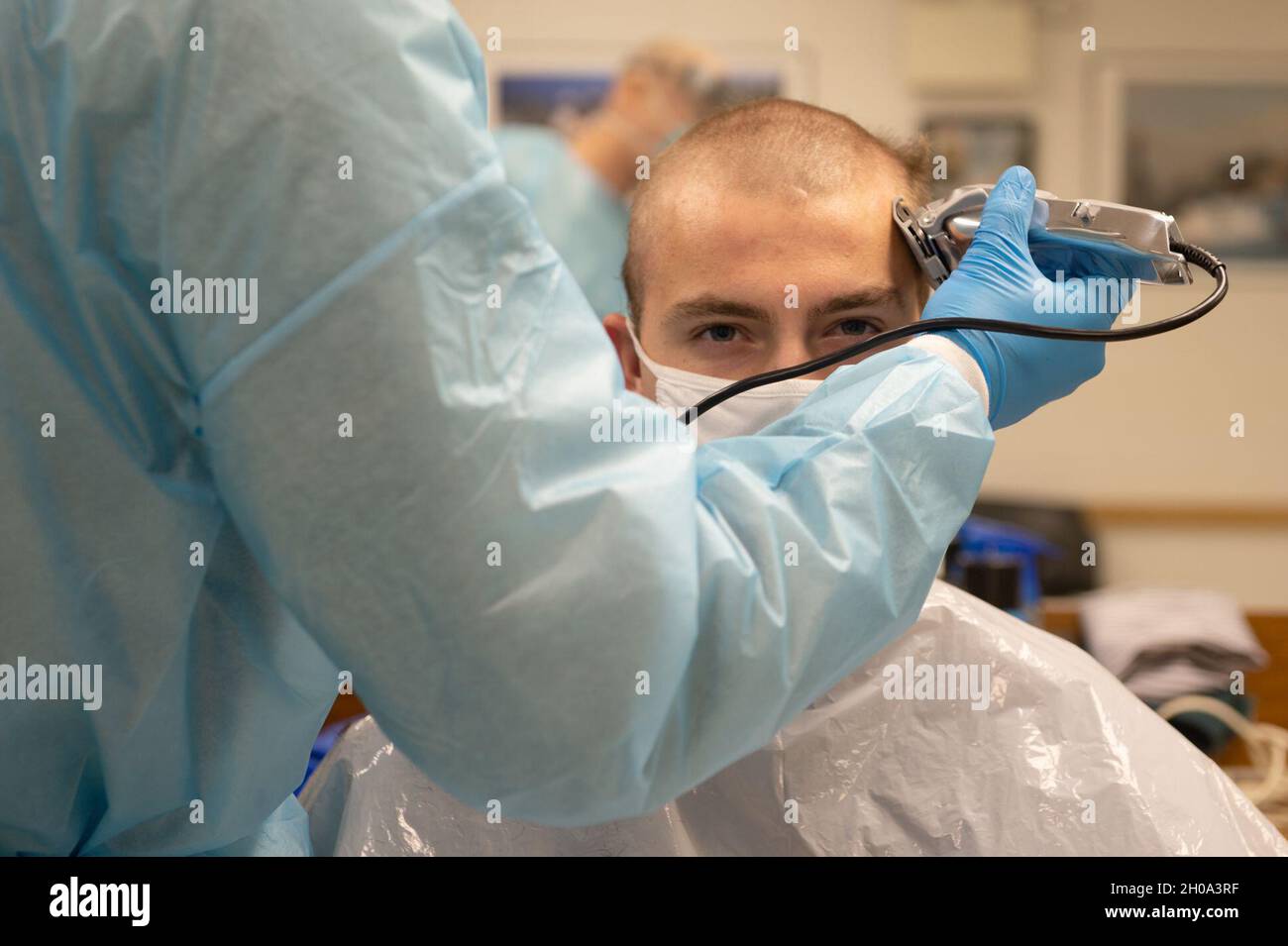 Recruits from company R-199 receive haircuts from staff members in ...