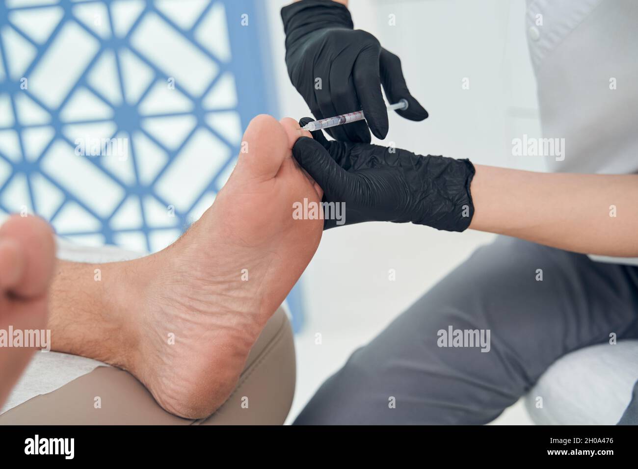 Man receiving foot injection on cosmetology clinic Stock Photo - Alamy