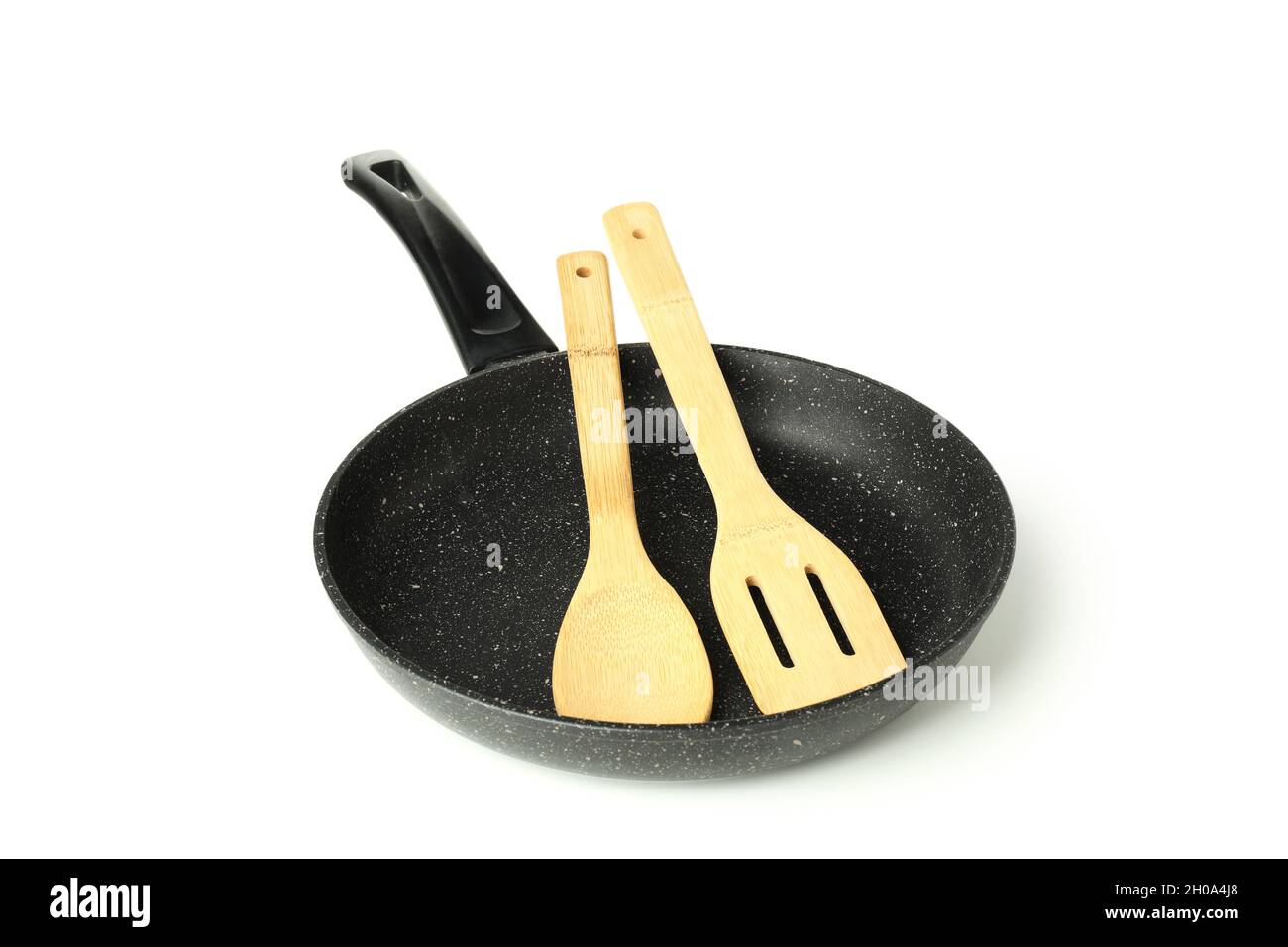 Pan with wooden utensil isolated on white background Stock Photo - Alamy