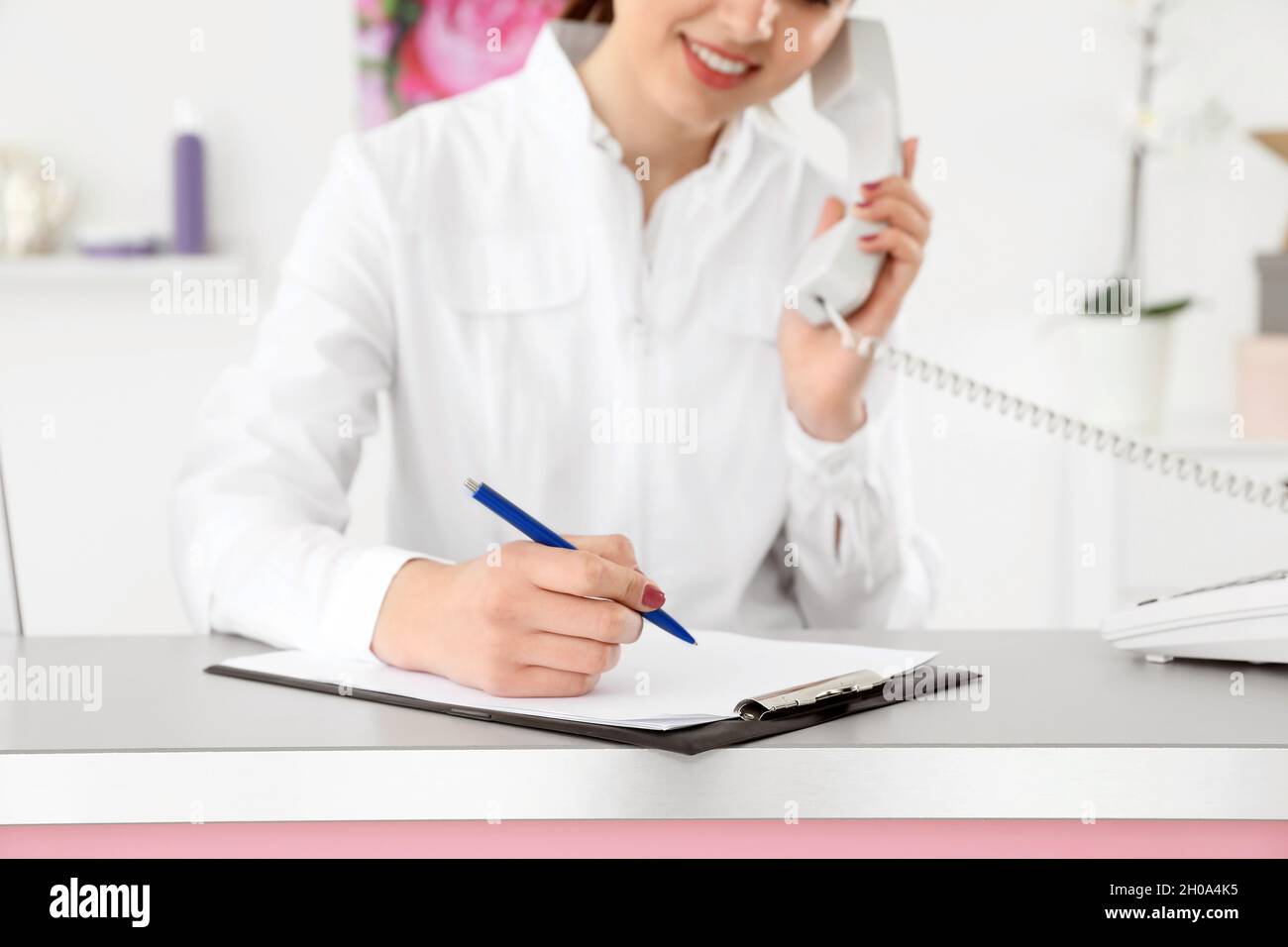 Salon receptionist phone hi-res stock photography and images - Alamy