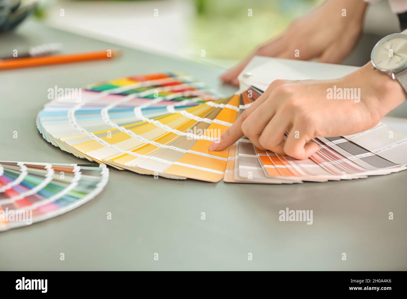 Female designer working with color palette samples at table Stock Photo ...