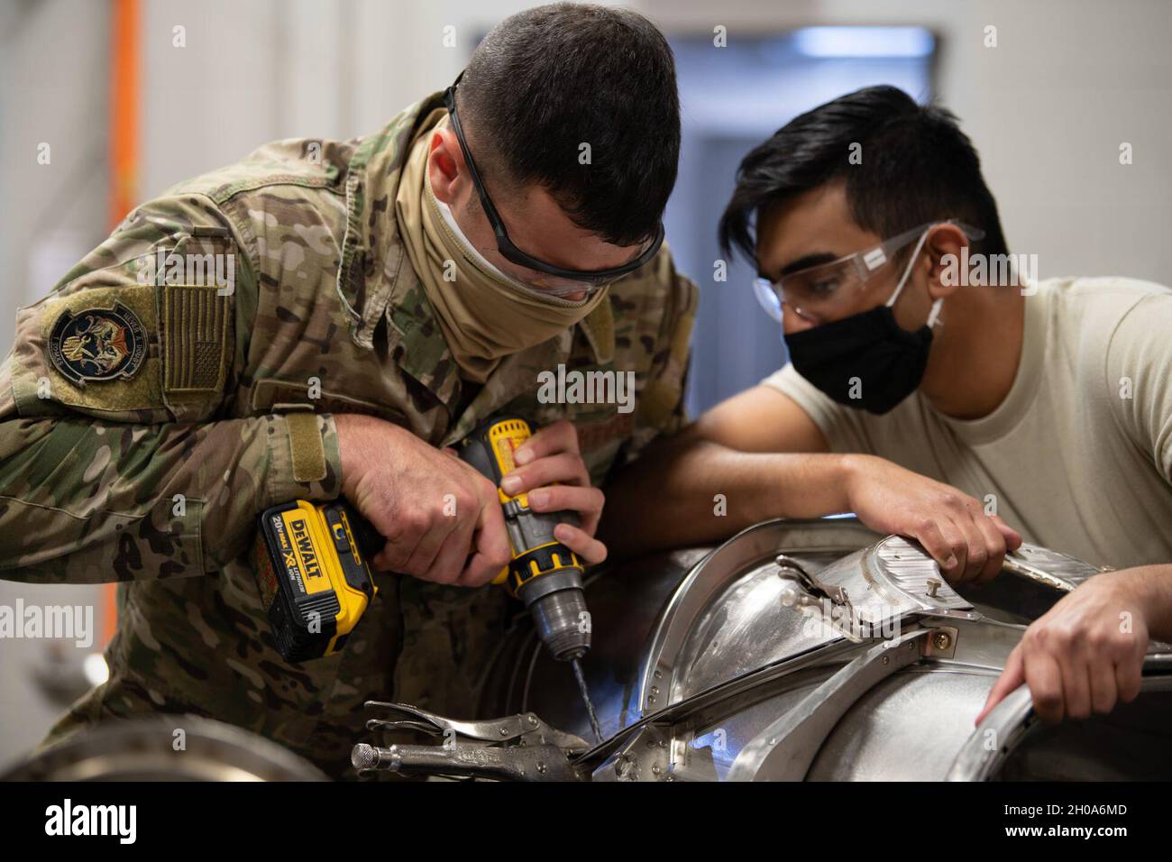 U.S. Air Force Staff Sgt. Blake Metscher, left, and Airman 1st Class ...
