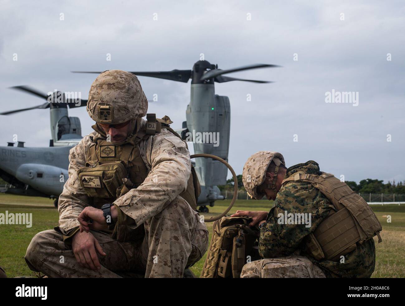 U.S. Marine Cpl. Ethan C. Brewer, left, a joint fires observer, and a ...