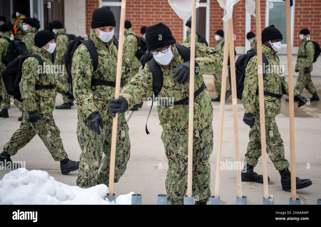 A recruit places their guideon in a stand as their division enters ...