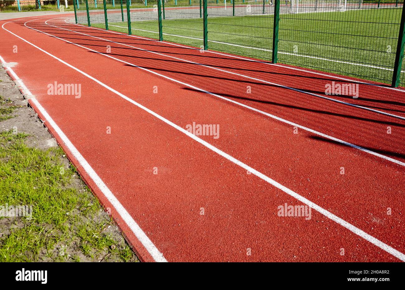 Red treadmill on sport field. Running track on the stadium Stock Photo ...