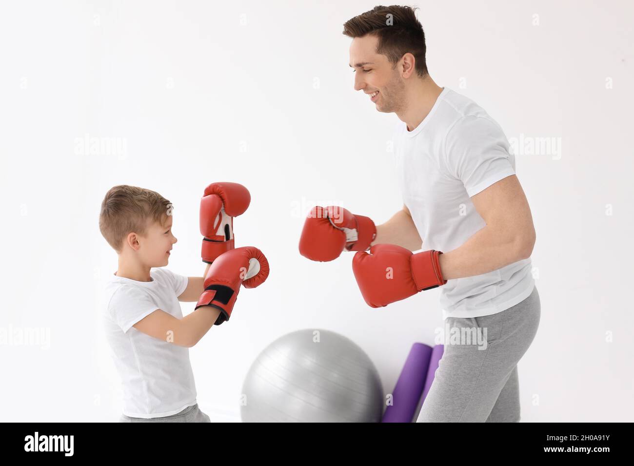Happy dad and his son boxing in gym Stock Photo - Alamy