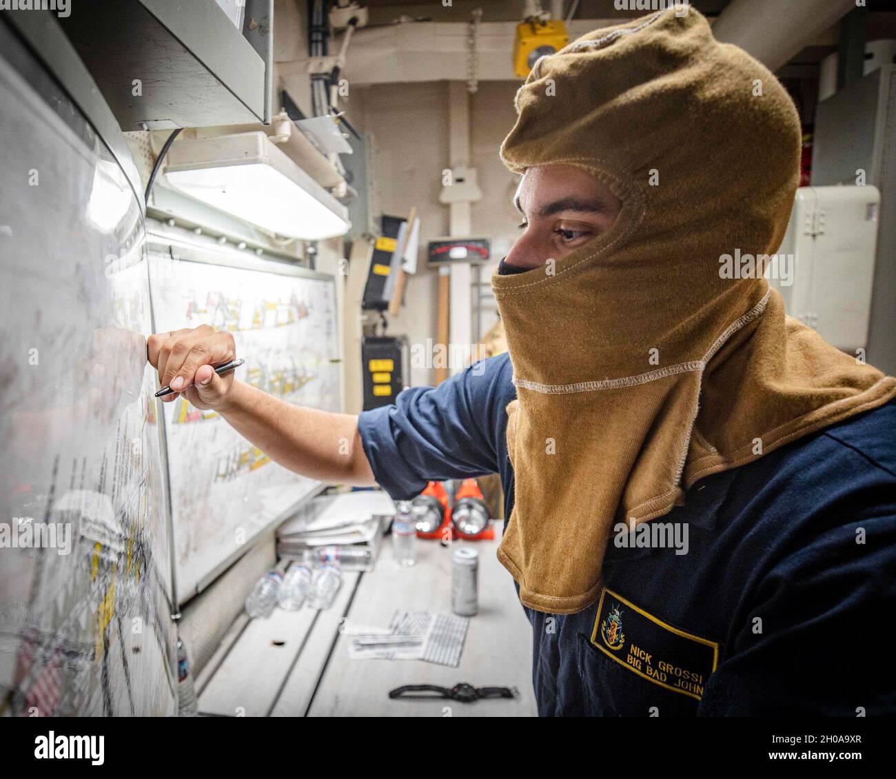 Ensign Nick Grossi, from Miami, charts zone-setting reports and status ...