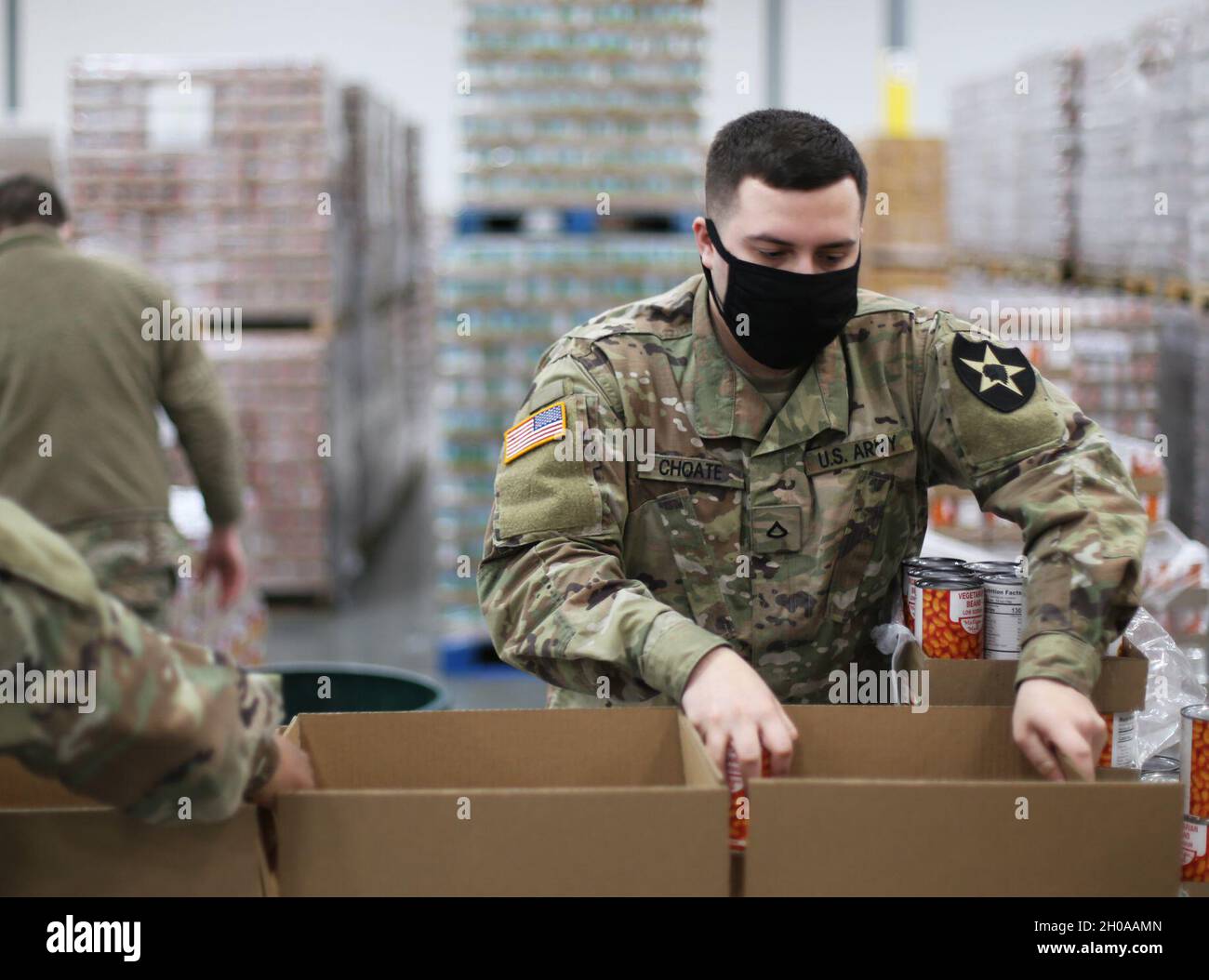 Private 1st Class Trenton Choate packs a food box at the Emergency Food ...