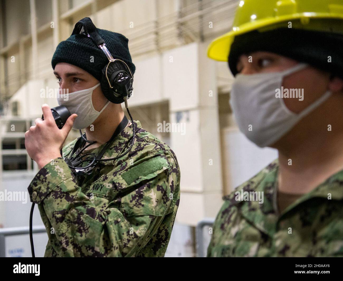 Recruit speaks on a sound powered telephone during an applied training ...