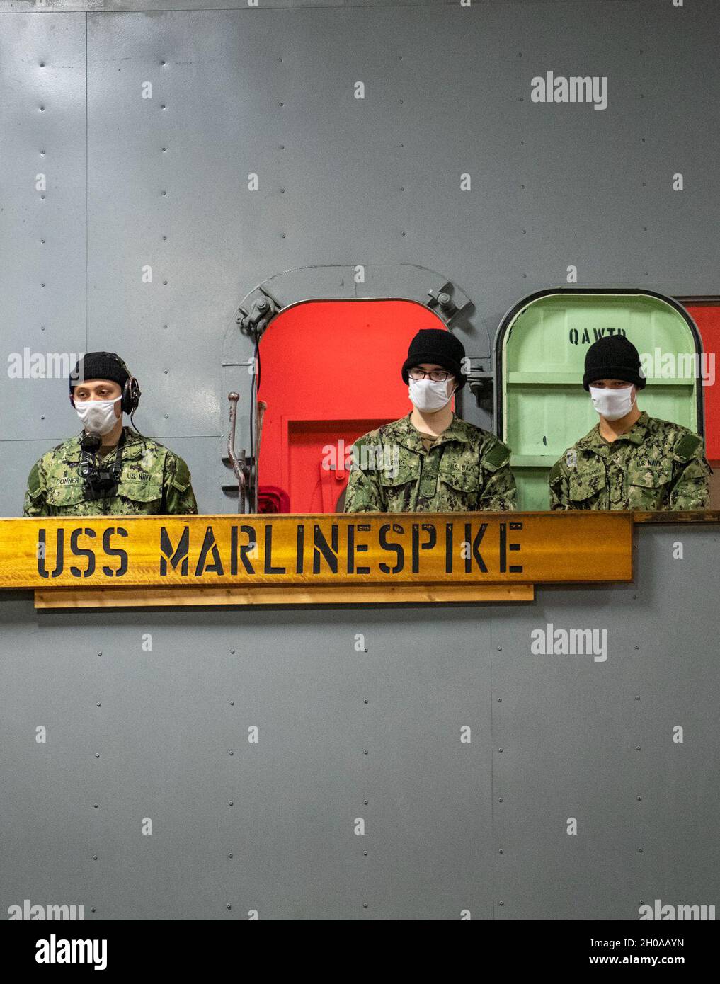 Recruits stand on the bridge of the USS Marlinespike during an applied ...