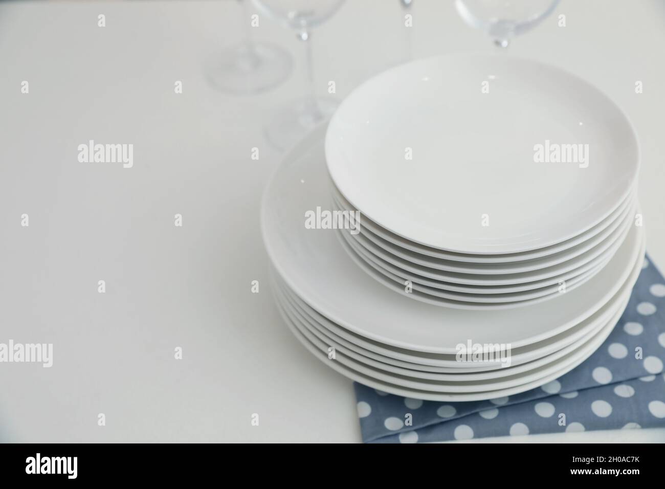 Stack of clean dishes on table in kitchen. Space for text Stock Photo ...