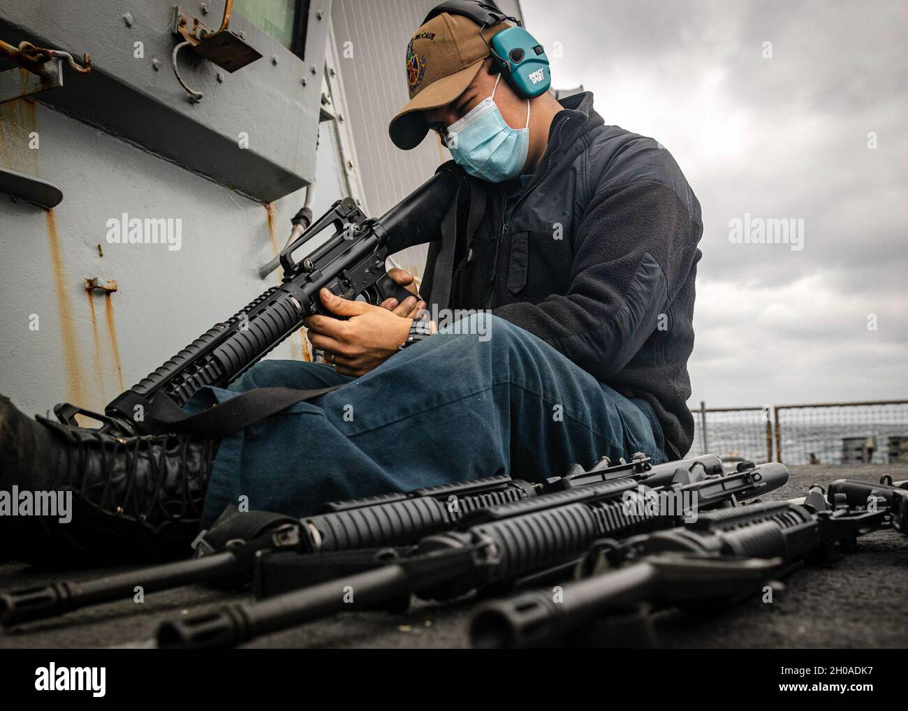Gunner’s Mate Seaman Carlos Ruiz, from Chicago, checks the sights on ...