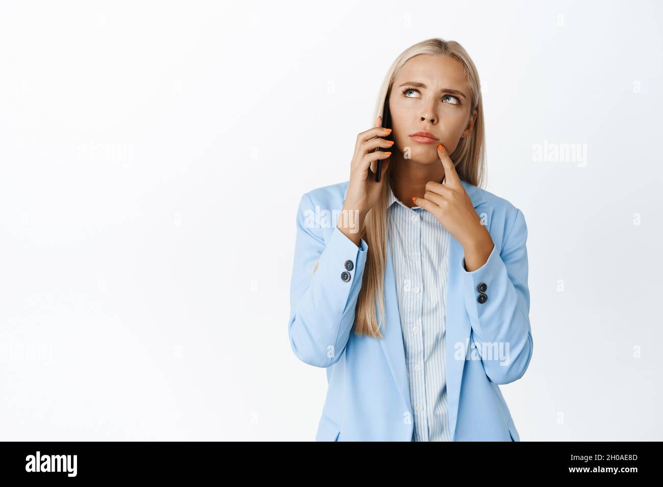 Thoughtful businesswoman having phone call, thinking or making decision ...