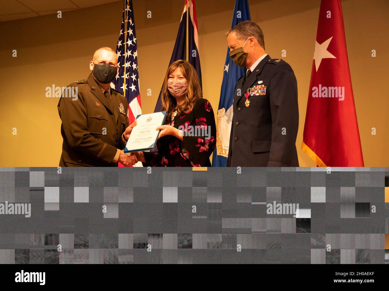 Col. Christopher Smith’s wife Shelley is presented with an award for ...