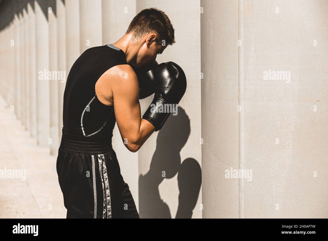 Man exercising and fighting in outside, boxer in gloves. male boxer ...