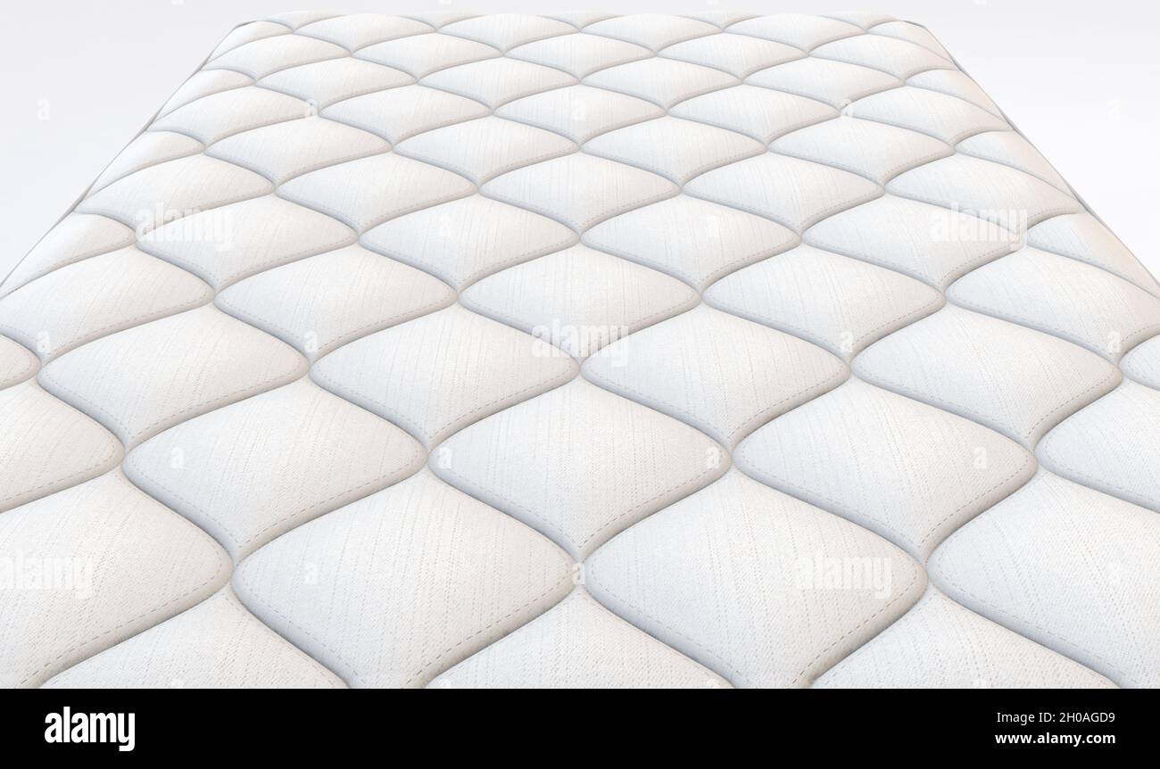 A simple white bed mattress with a decorative topping and fabric sides ...