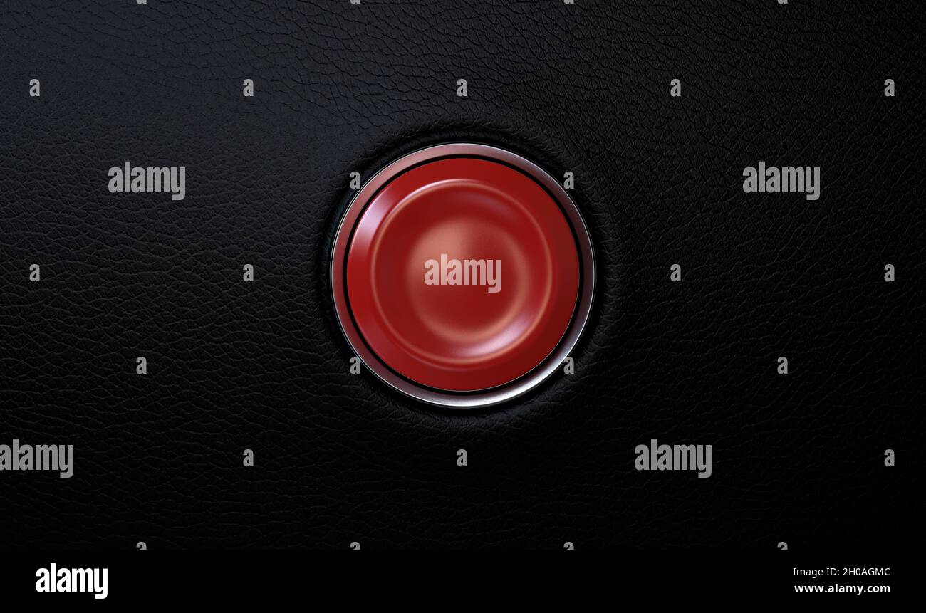 A closeup of a round red button set in a black leather textured surface ...